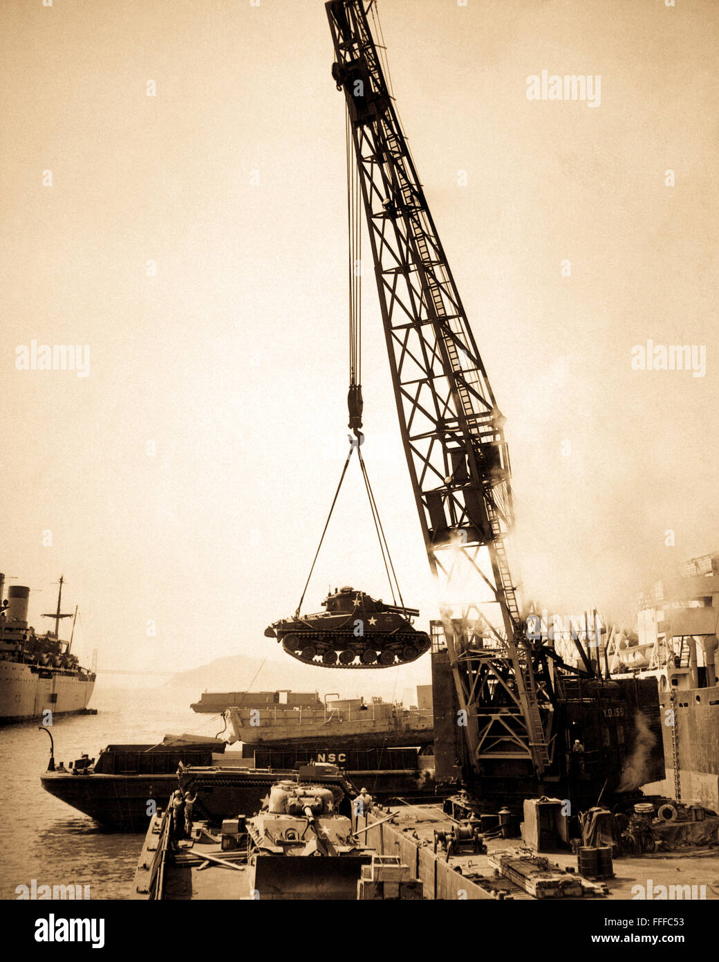 Marine Corps tanks - ready for the front lines - are swung aboard a ...