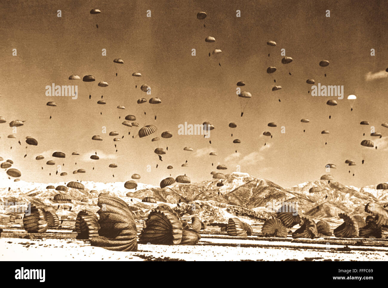 Men and equipment being parachuted to earth in an operation conducted ...