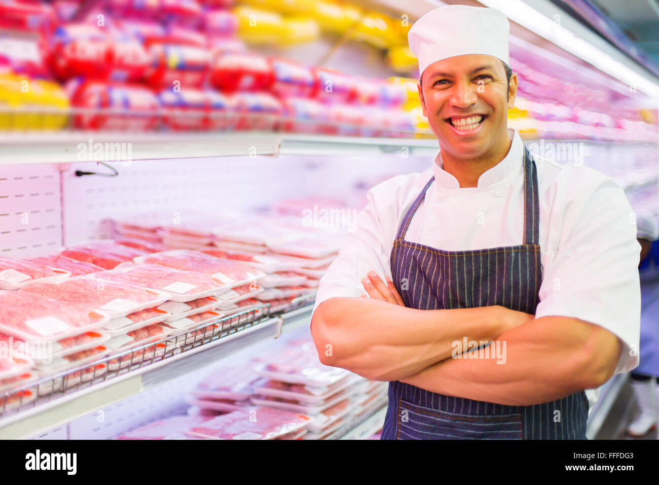 cheerful middle aged butcher standing in butchery Stock Photo - Alamy