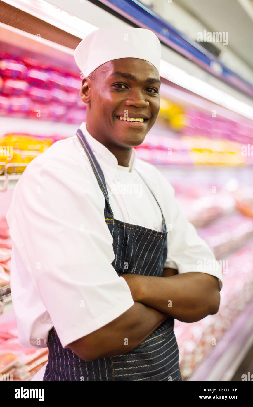 handsome African butcher with arms crossed in butchery Stock Photo - Alamy