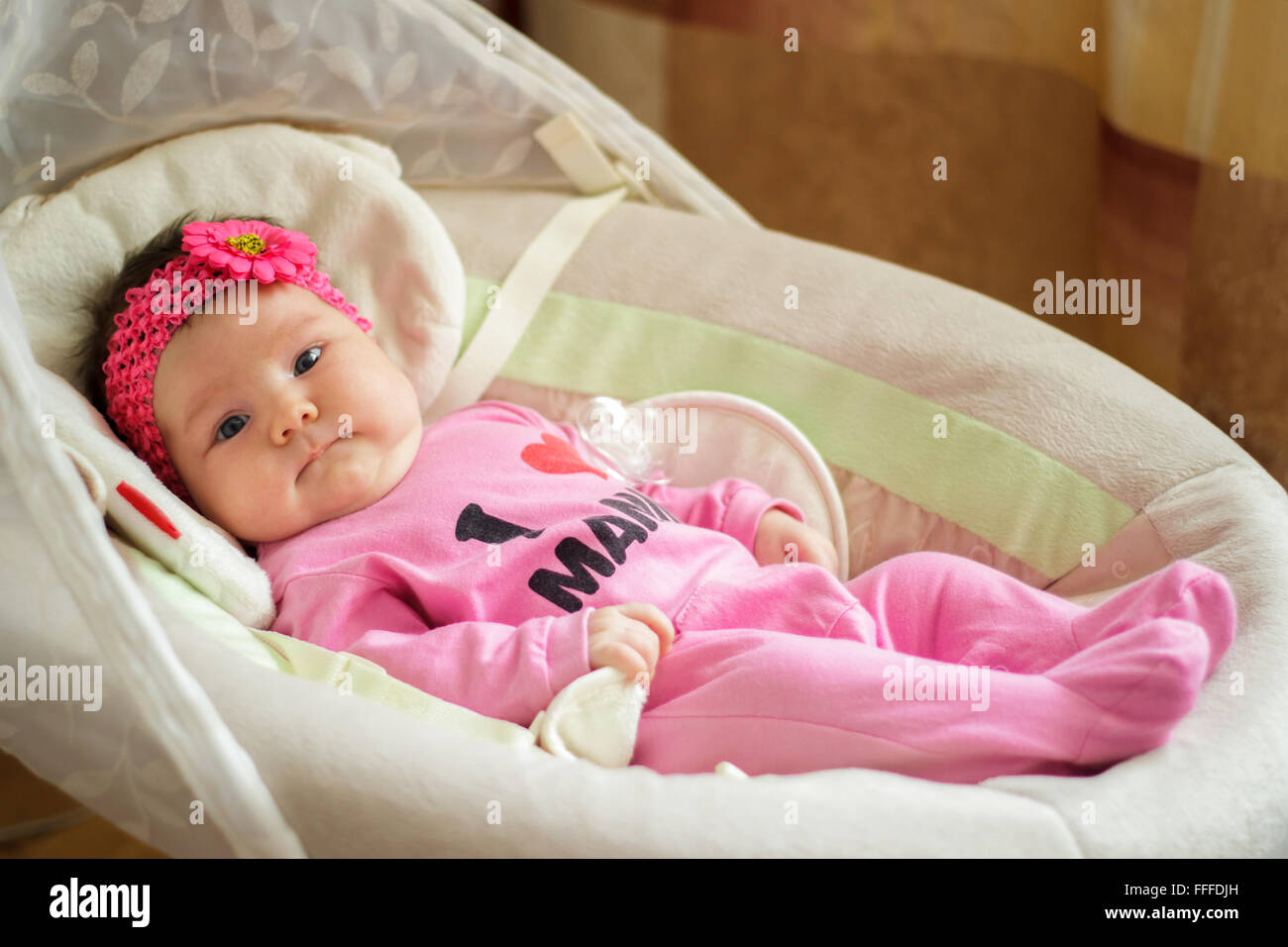 Little beautiful girl lies in a cradle Stock Photo - Alamy