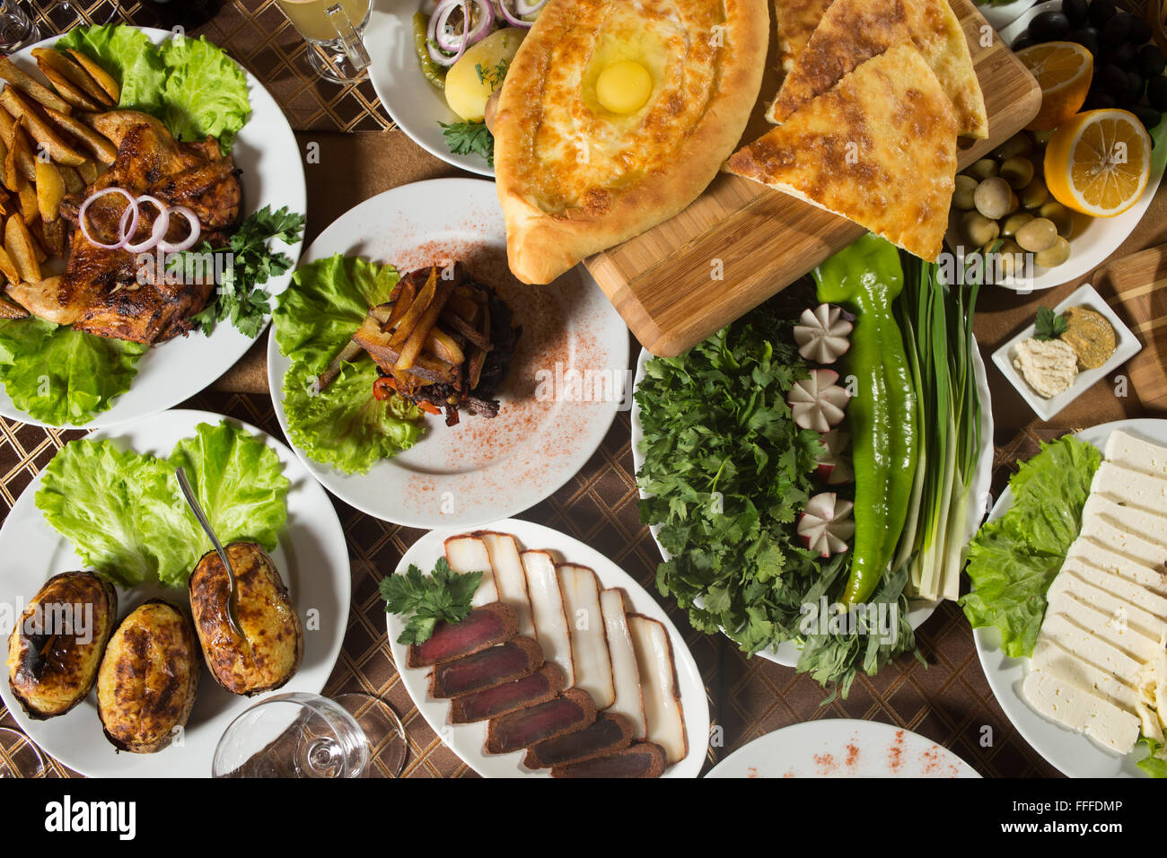 table with normal food, steaks and potatoes Stock Photo - Alamy