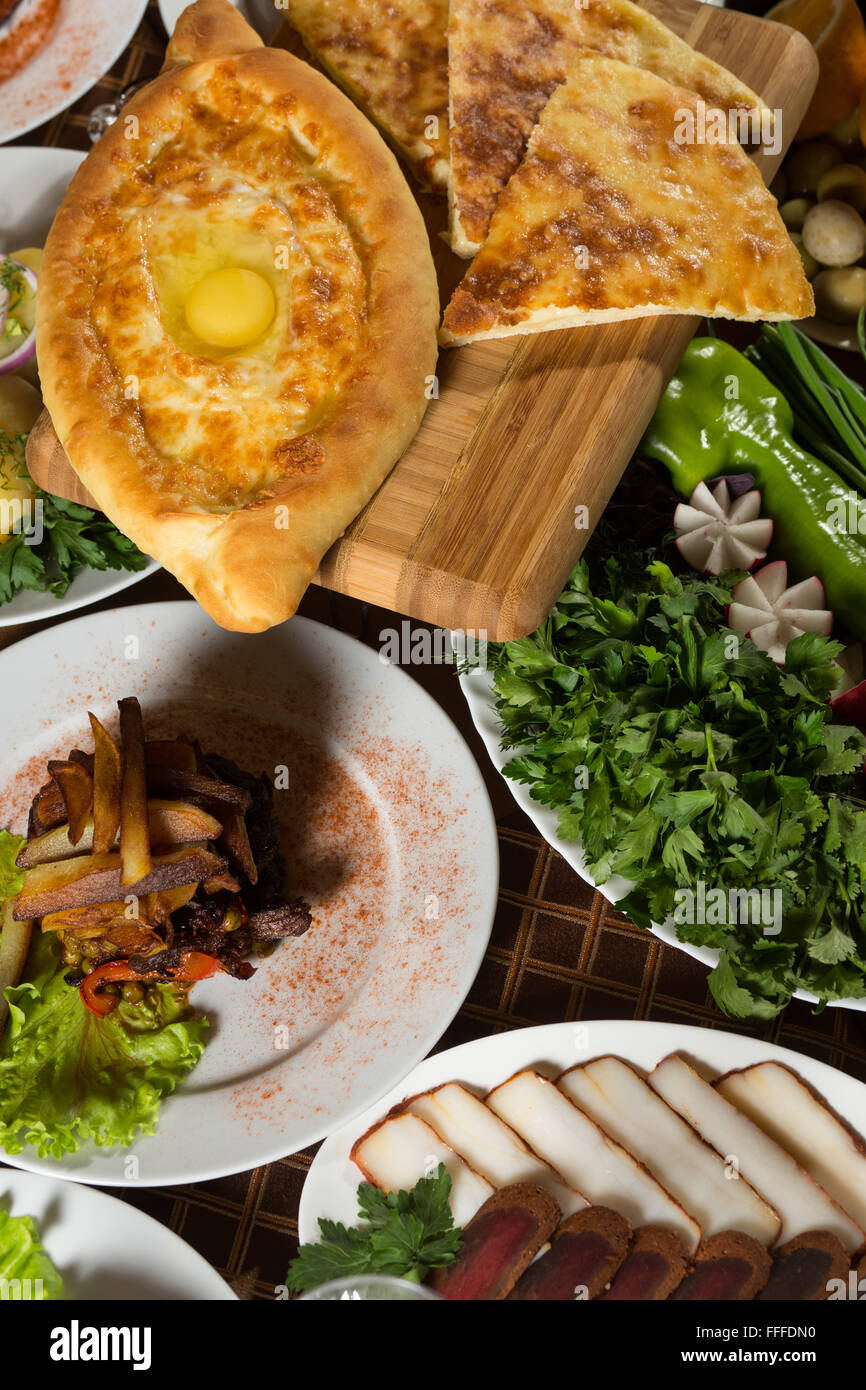 table with normal food, steaks and potatoes Stock Photo - Alamy