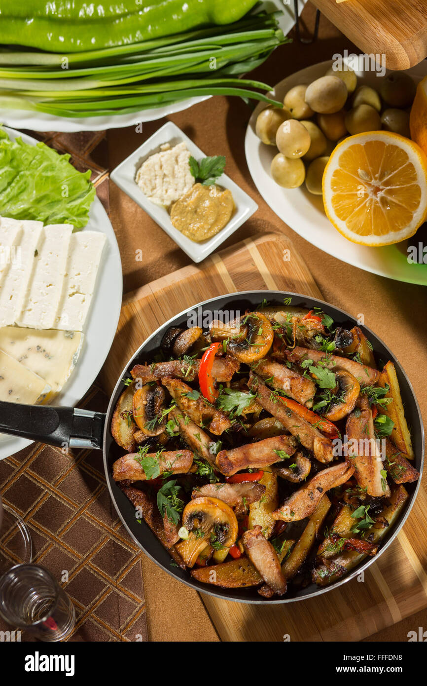 table with normal food, steaks and potatoes Stock Photo - Alamy