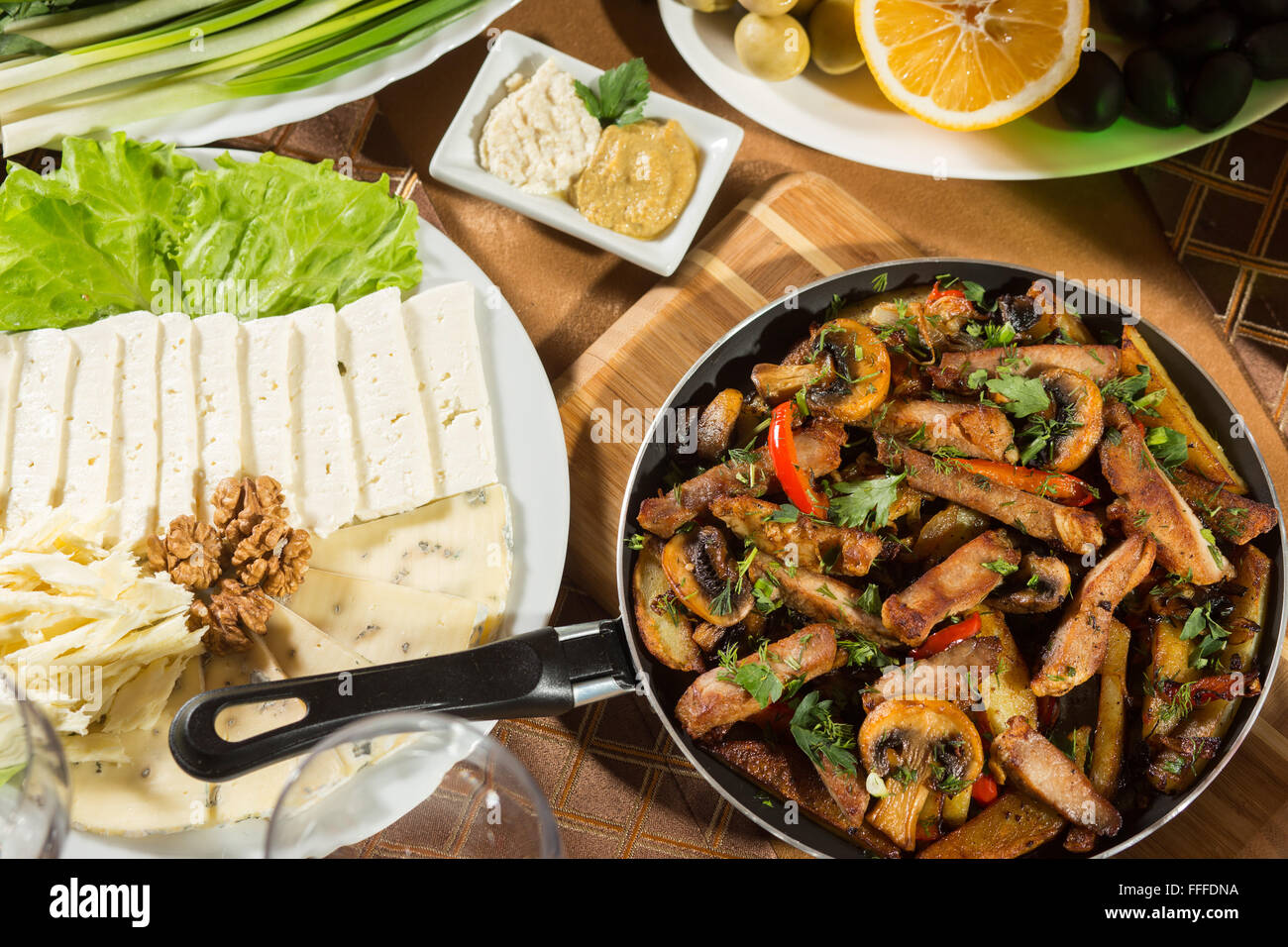 table with normal food, steaks and potatoes Stock Photo - Alamy