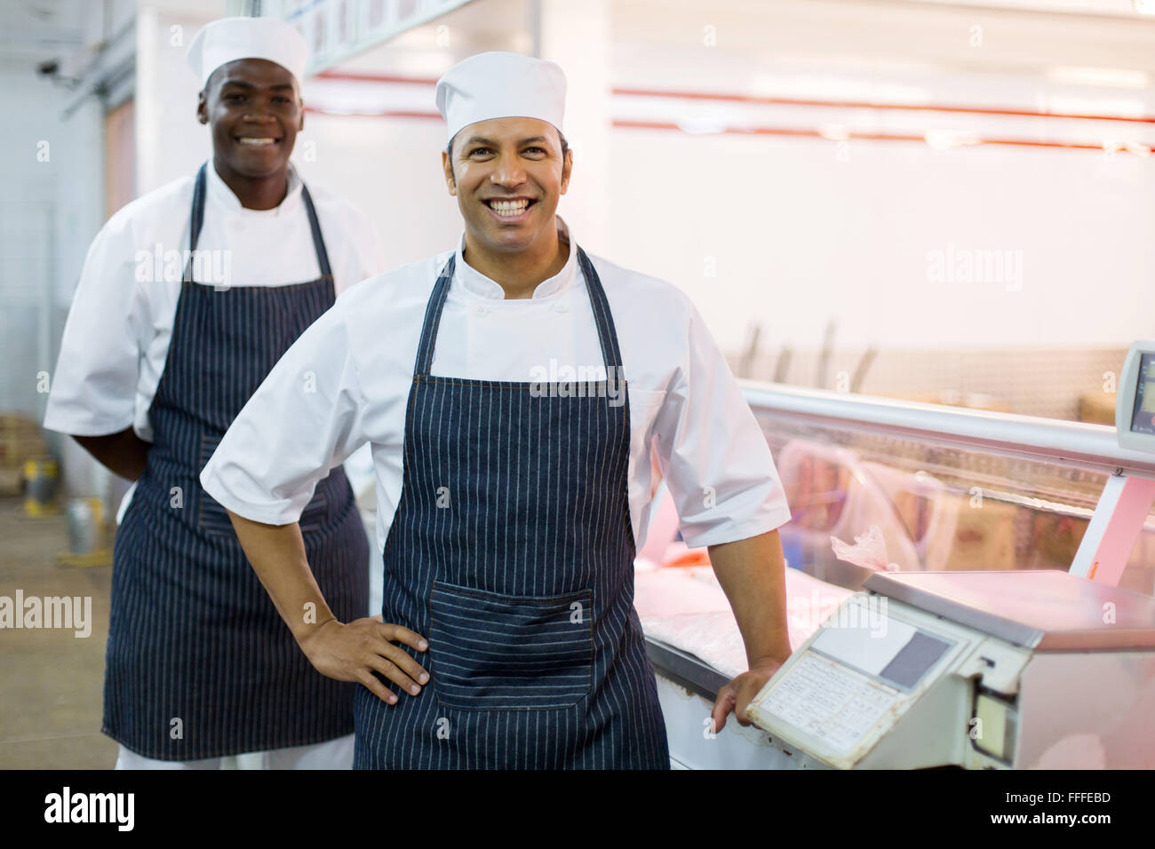 portrait of happy butchery workers standing next to scale Stock Photo ...