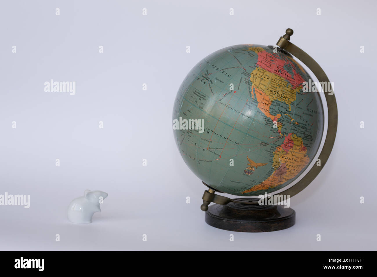 Porcelain mouse staring at a globe Stock Photo - Alamy