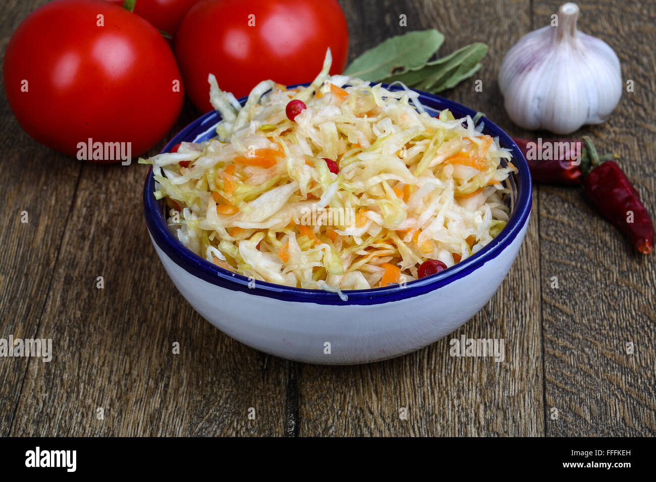 Fermented cabbage - Sauerkraut with herbs and spices on the wood ...