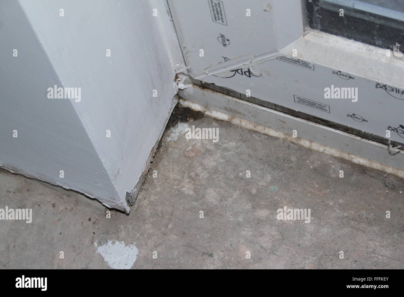 badly sealed pvc door with damp and cracks in the floor Stock Photo - Alamy