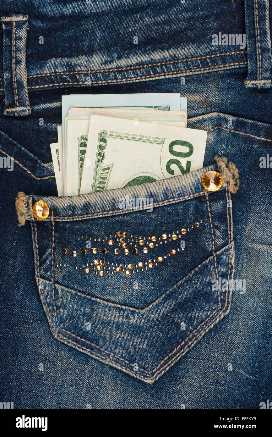 Money sticks out of the pocket of his jeans with rhinestones, as ...