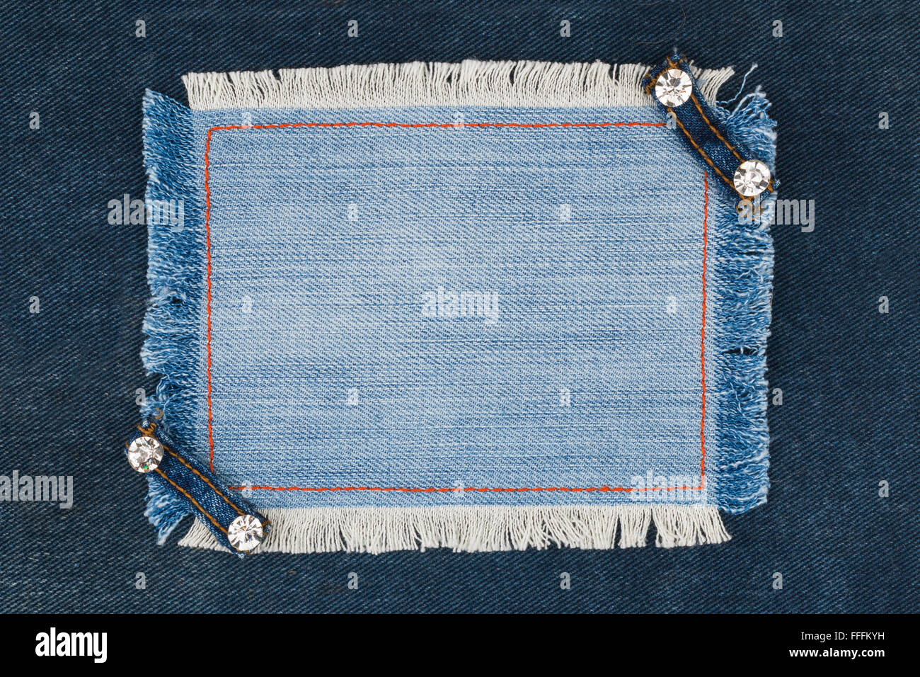 Frame with two straps jeans and rhinestones, lies on the dark denim ...