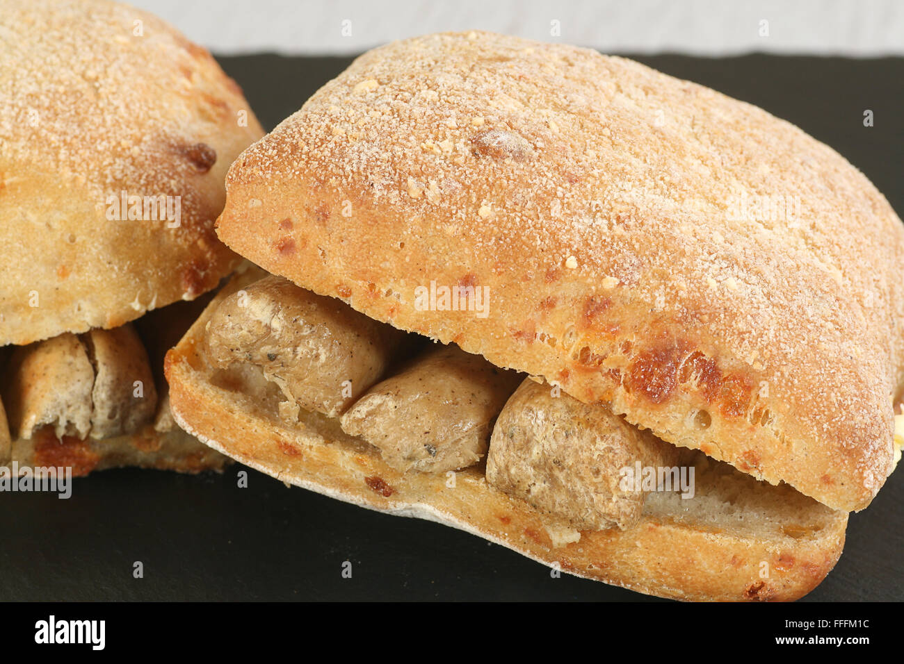 grilled vegetarian sausage on a crusty bread cob Stock Photo - Alamy