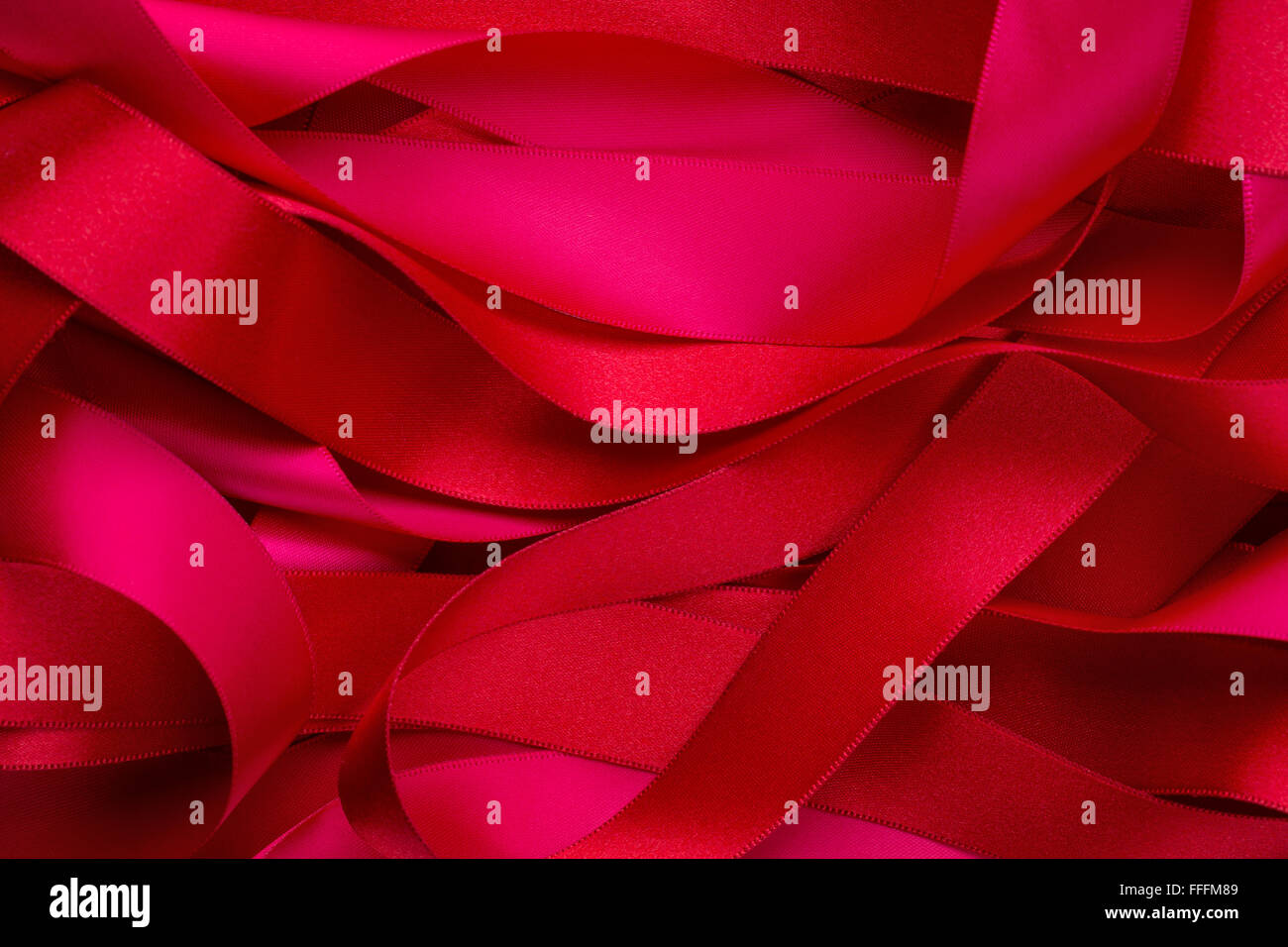 Curly red ribbon,ribbon background Stock Photo - Alamy