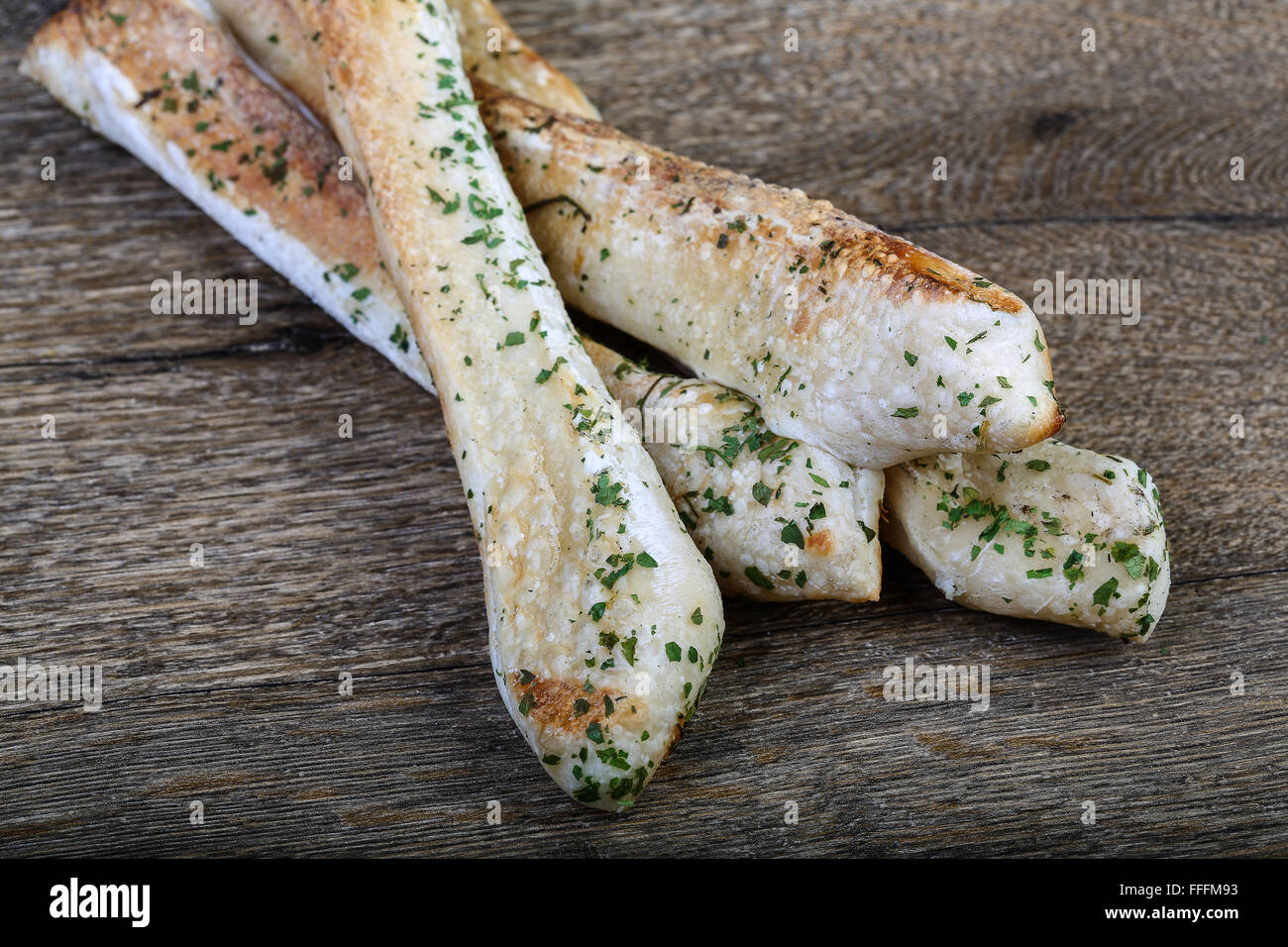 Italian bread stick with herbs on the wood background Stock Photo - Alamy