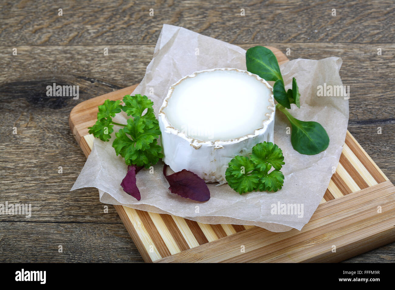 Goat cheese with white mold served parsley leaves Stock Photo - Alamy