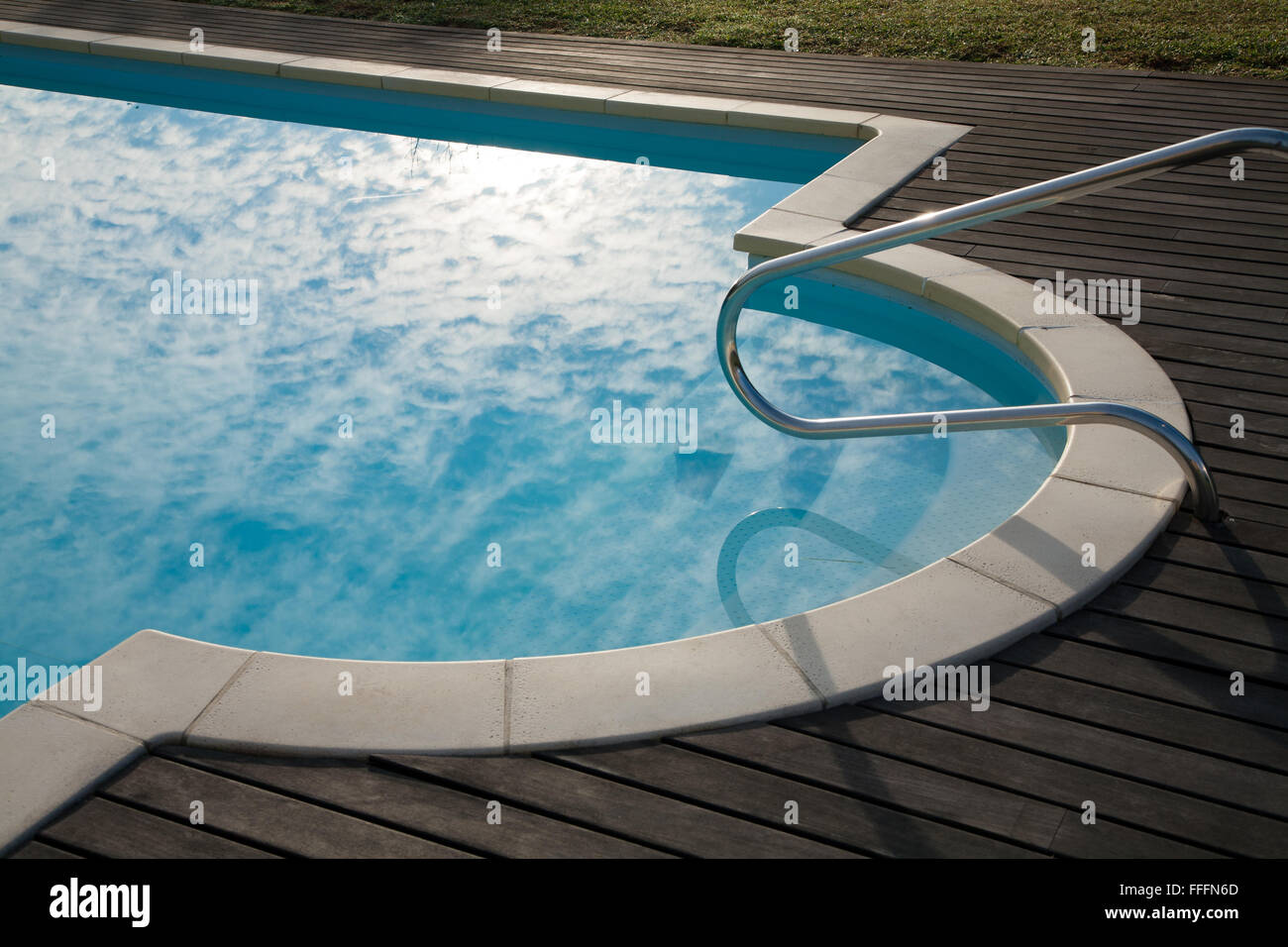 beautiful detail of swimming pool with cloudy sky reflected on blue ...