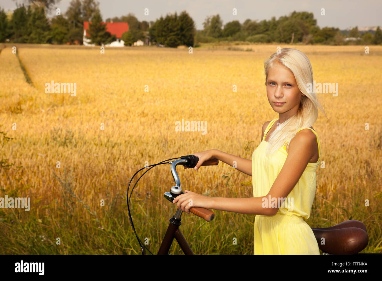 Young girl with a bike on the wheat field background Stock Photo - Alamy
