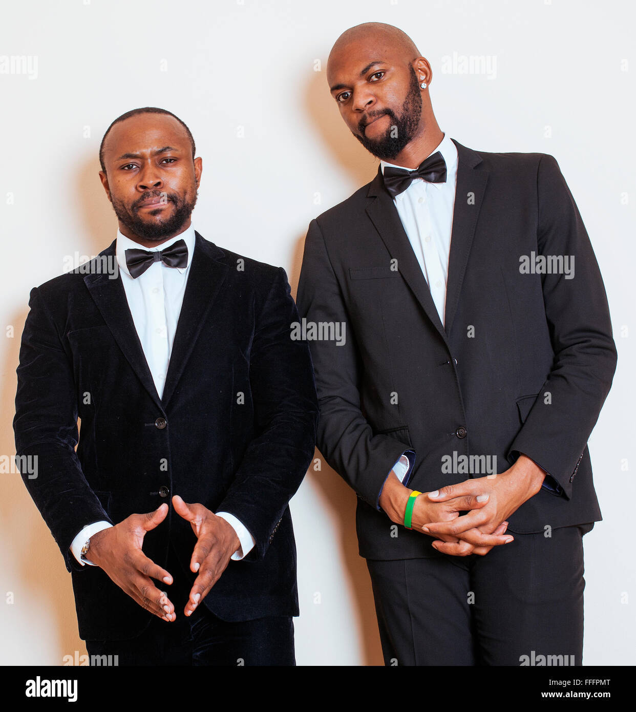two afro-american businessmen in black suits emotional posing ...