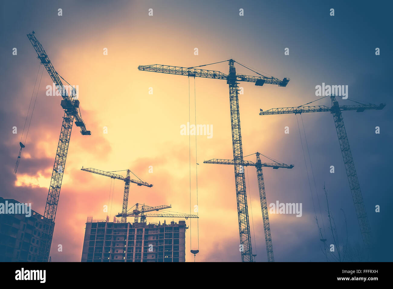 Abstract Industrial background with construction cranes silhouettes ...