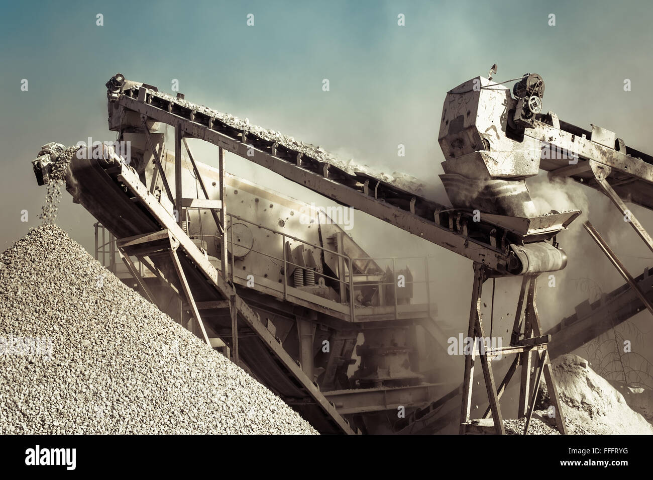 Industrial background with working gravel crusher Stock Photo - Alamy