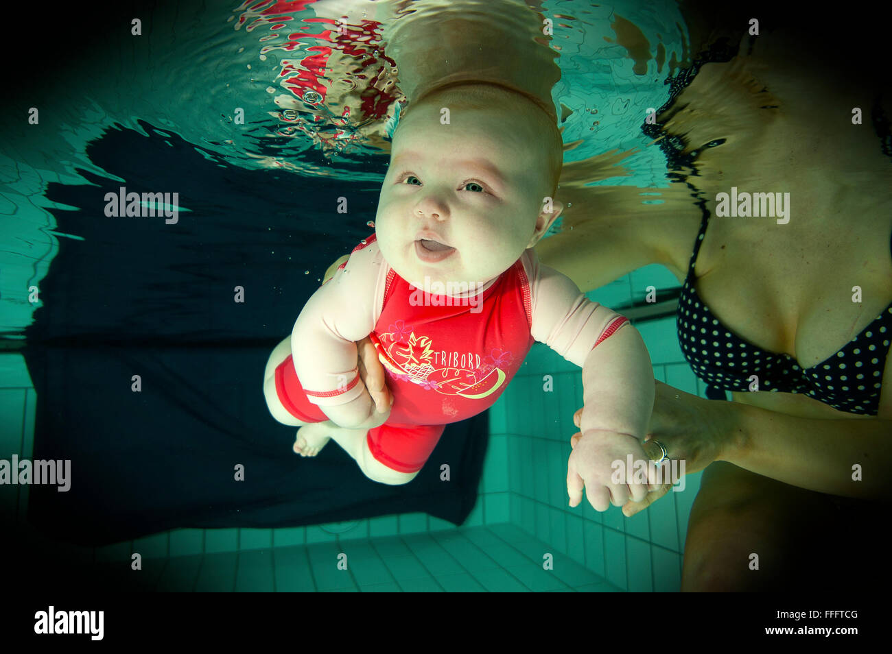 Baby swimming underwater Stock Photo - Alamy