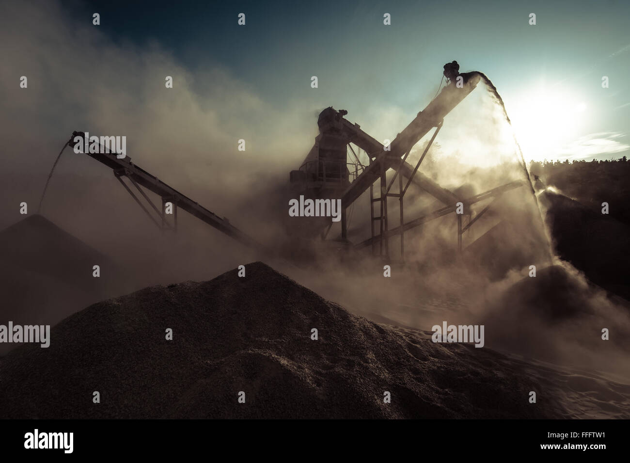 Industrial background with working gravel crusher Stock Photo - Alamy