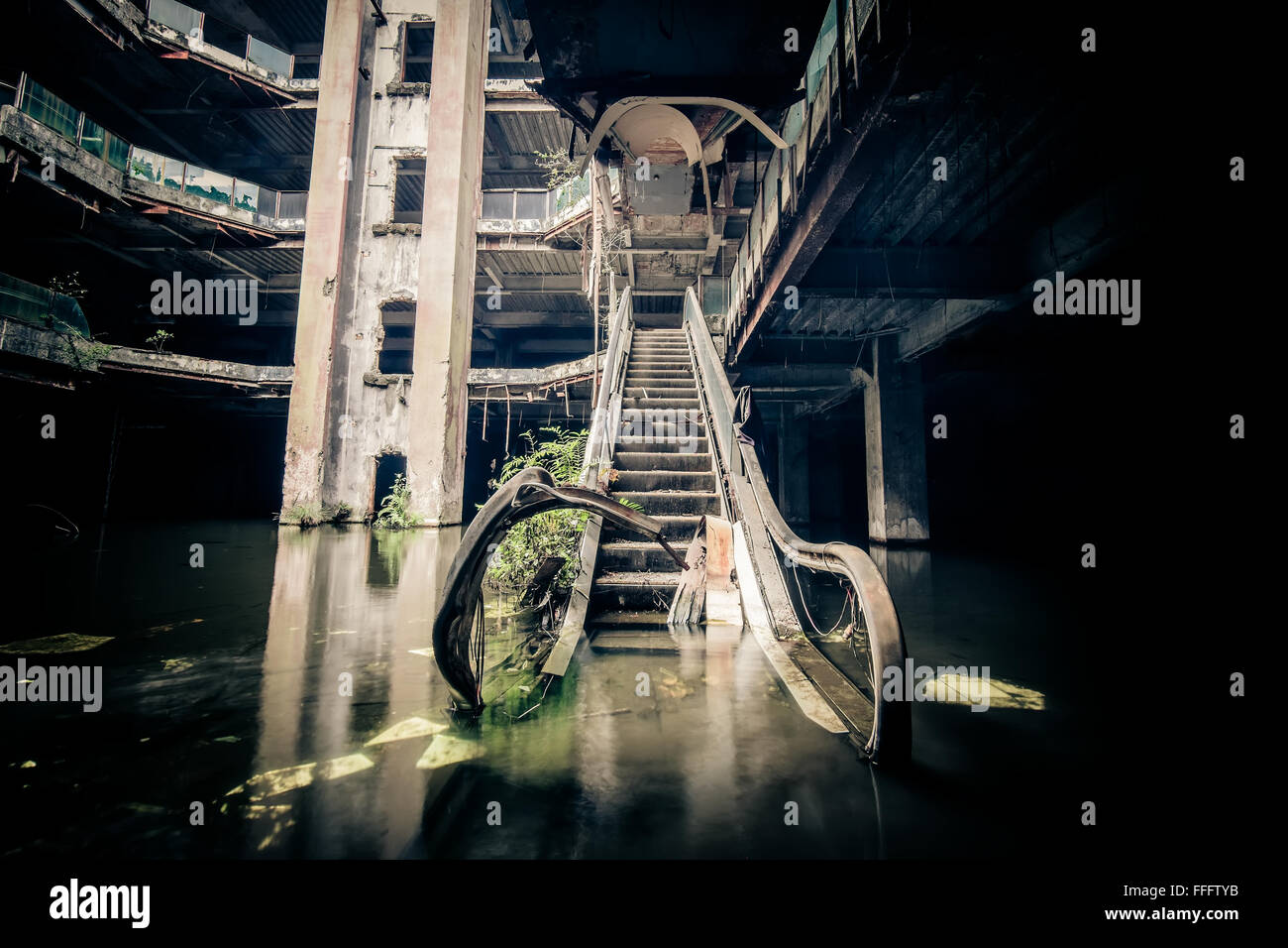 Dramatic view of damaged escalators in abandoned shopping mall sunken ...