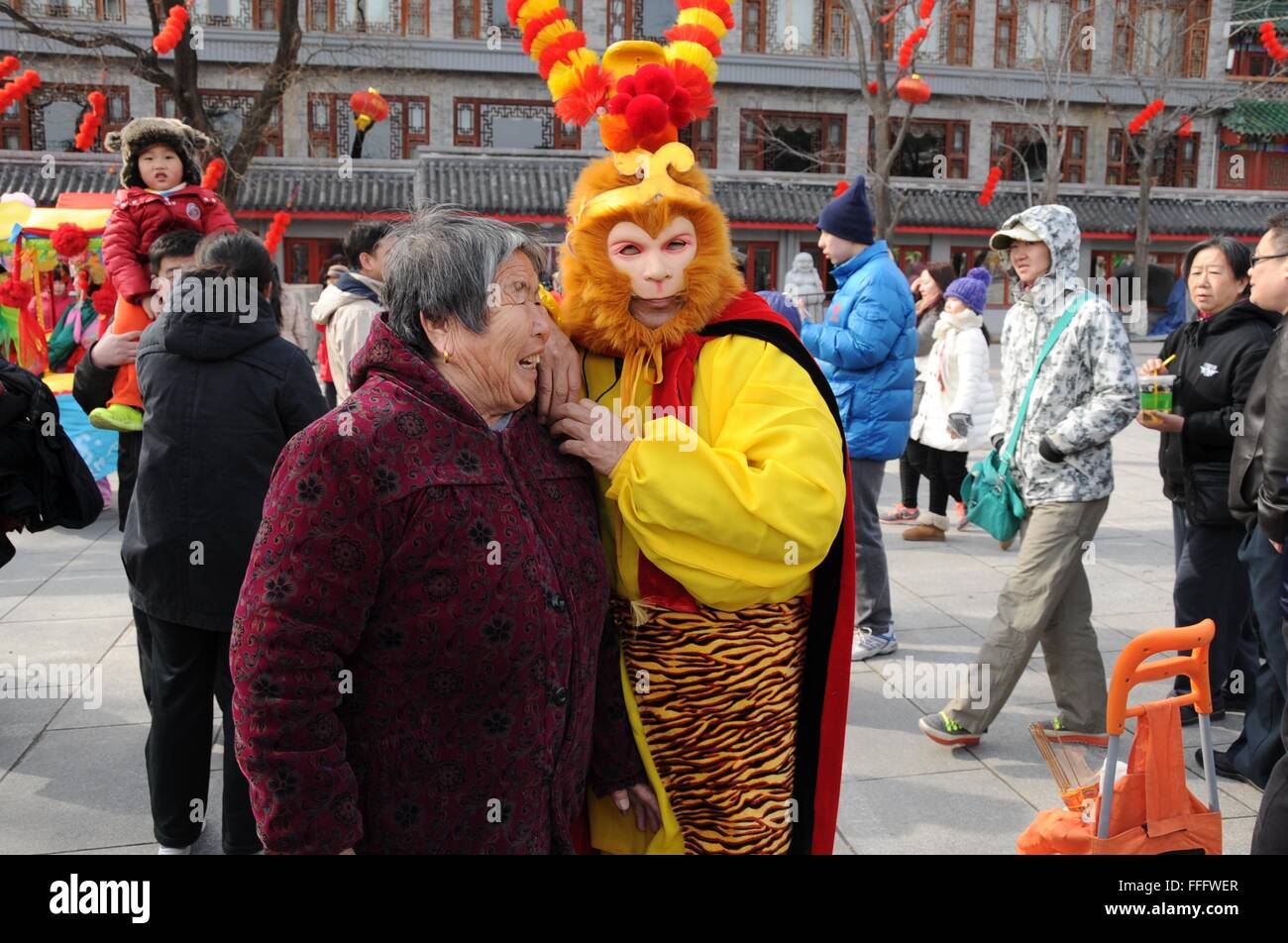Beijing, China. 13th Feb, 2016. A tourist poses with the "Monkey King ...