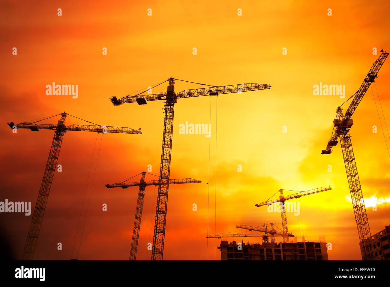 Abstract Industrial background with construction cranes silhouettes ...