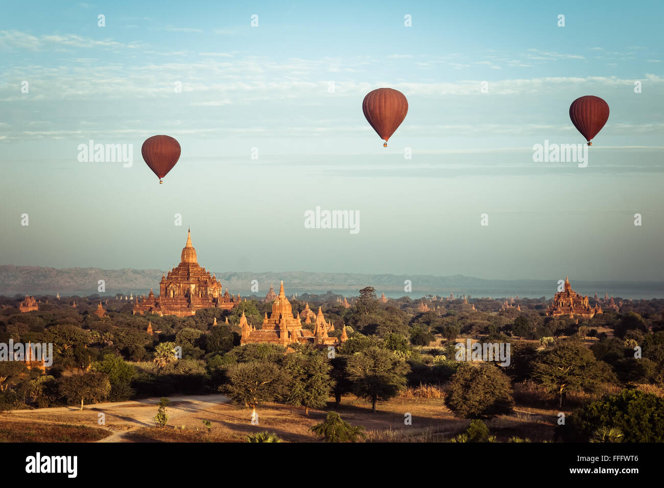 Hot air balloons flying at sunrise over ancient Buddhist Temples at ...