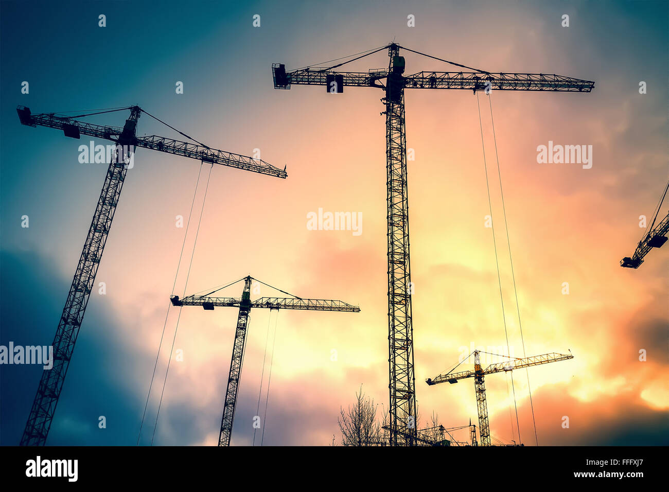Abstract Industrial background with construction cranes silhouettes ...