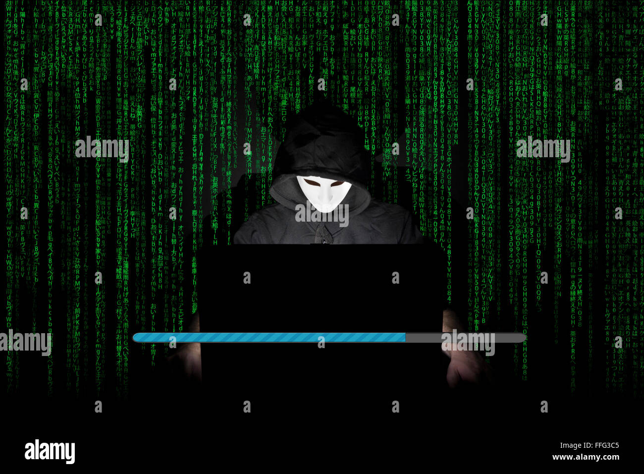 A masked man at a laptop symbolising the dangers of the Internet Stock ...