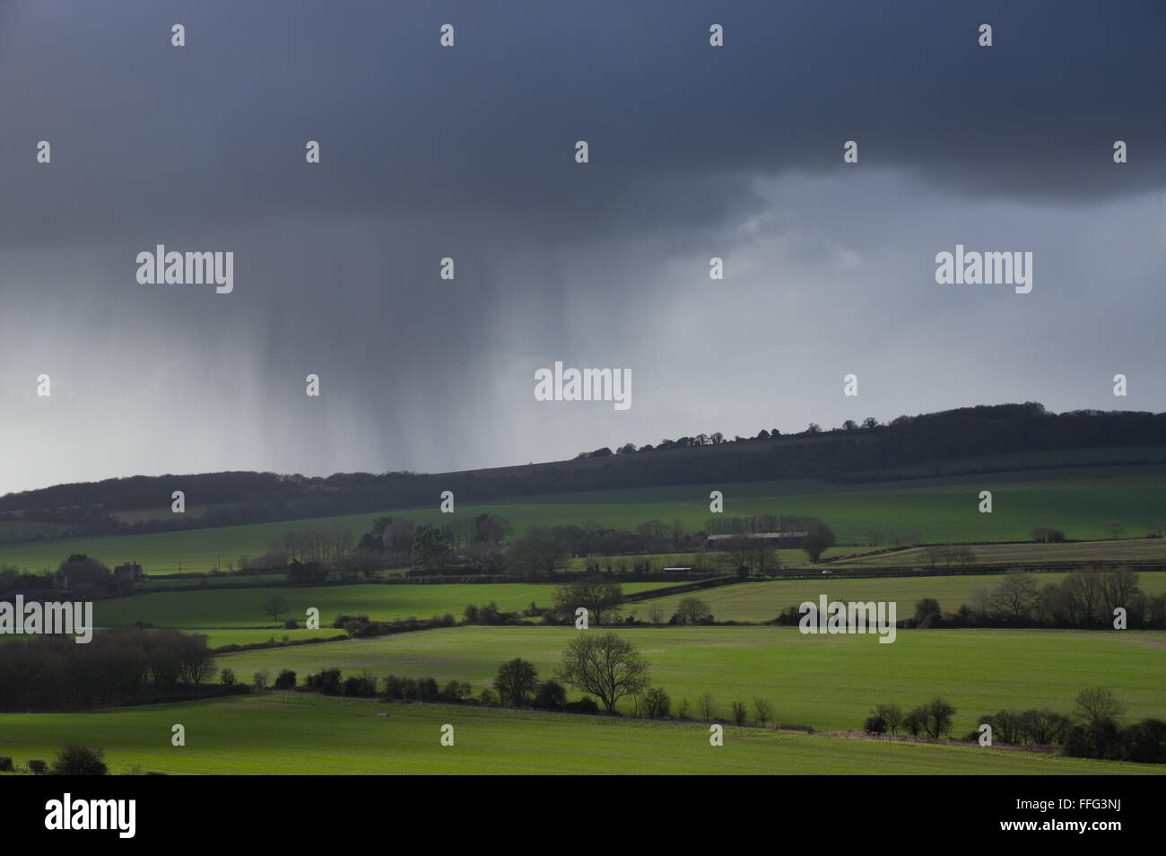 Rain falling over green fields Stock Photo - Alamy