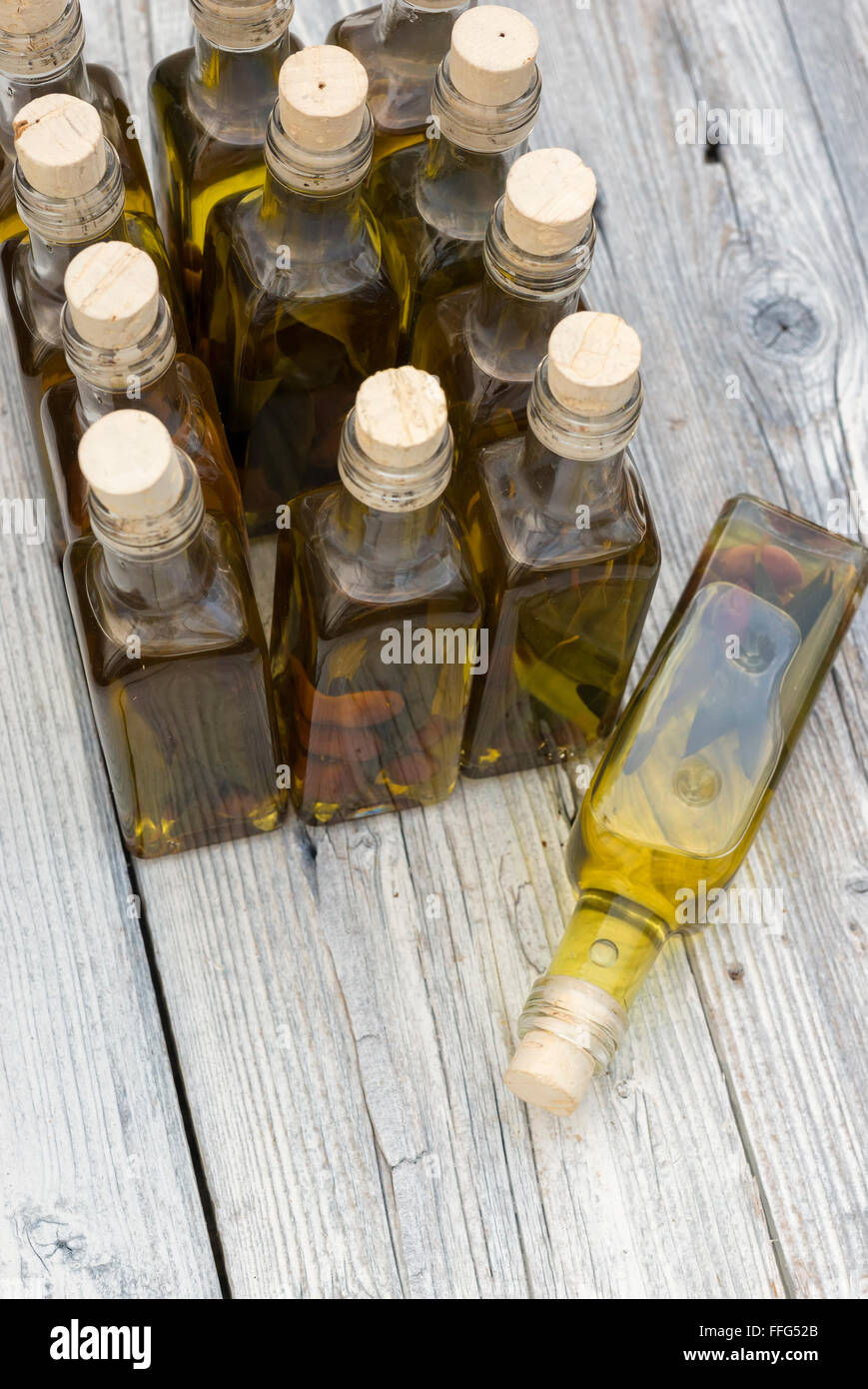 olives and olive oil in mini bottle on wood table Stock Photo - Alamy