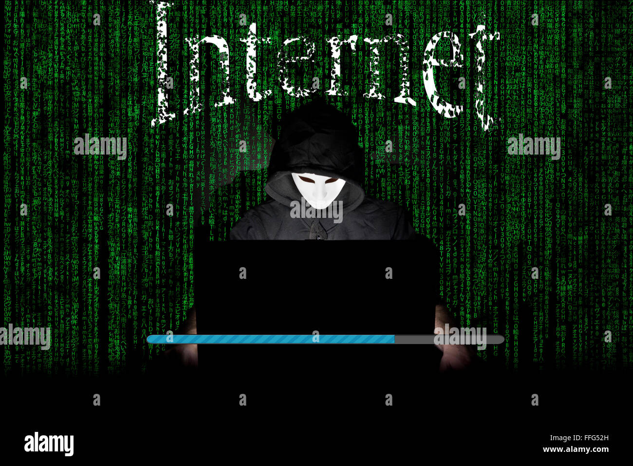 A masked man at a laptop symbolising the dangers of the Internet Stock ...