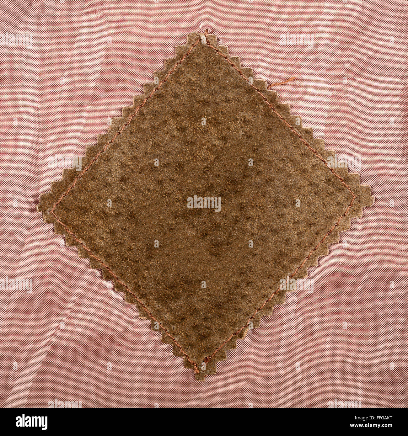 Empty old suede label sewed on brown fabric Stock Photo - Alamy