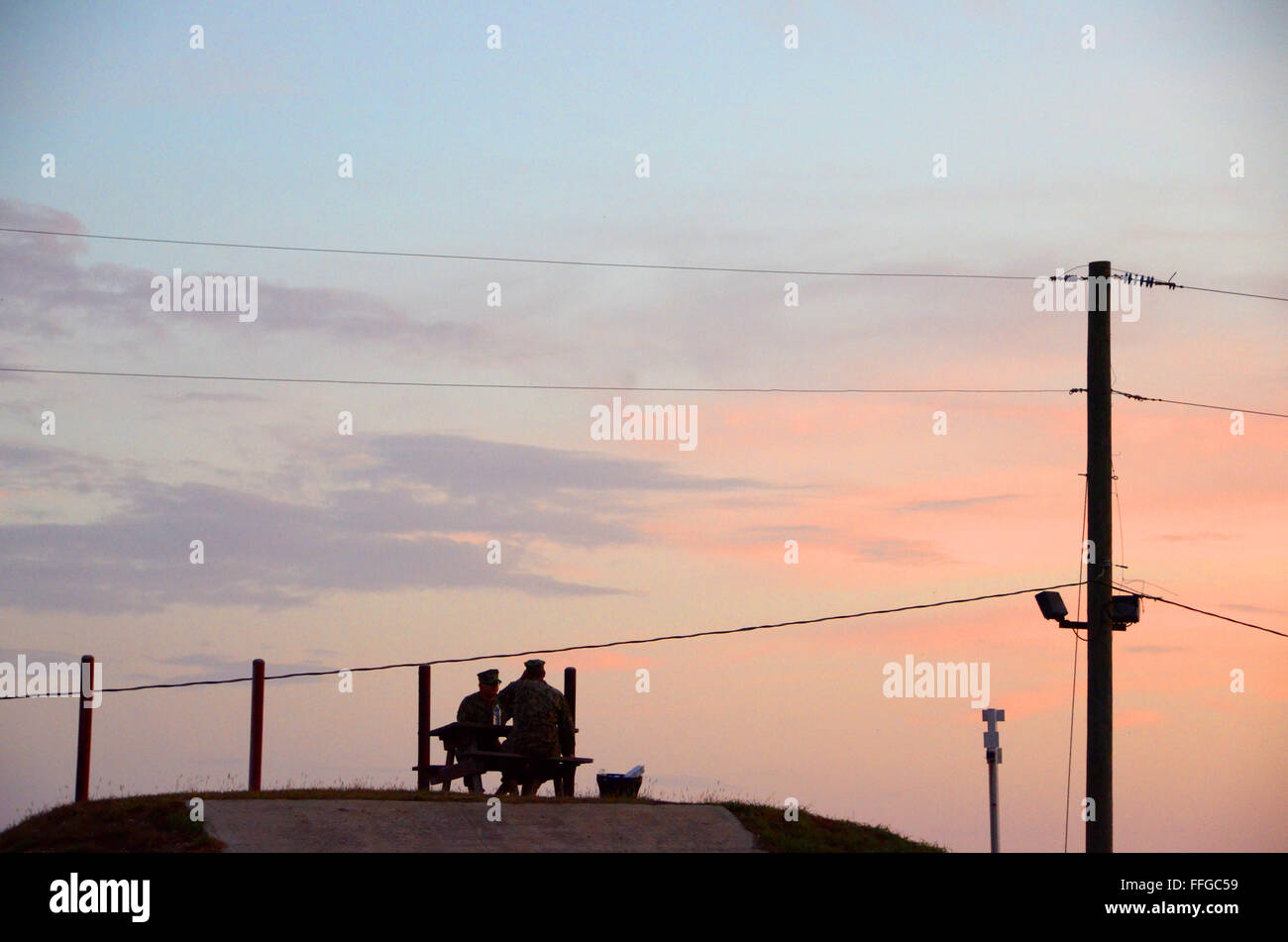 guantanamo bay cuba gtmo soldiers at table at sunset Stock Photo - Alamy