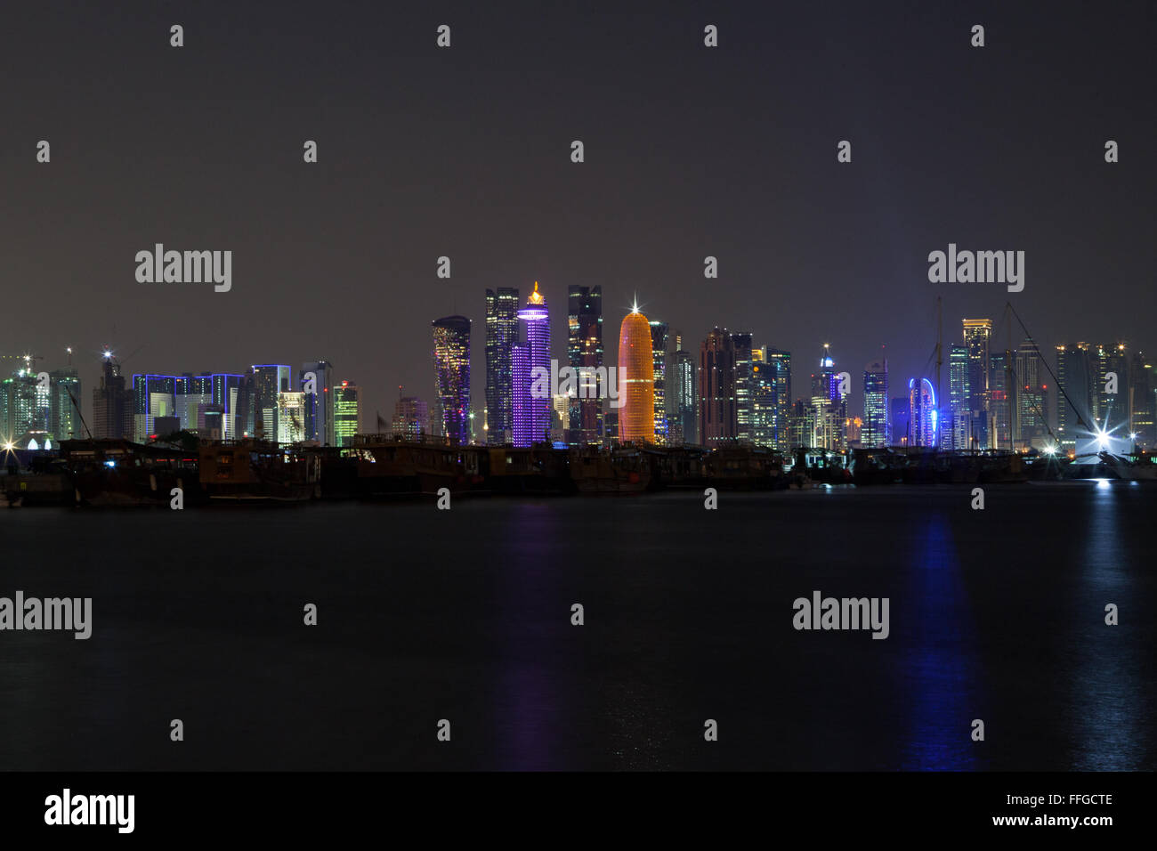 Doha Financial District skyline at night. Colourful night-time lights ...