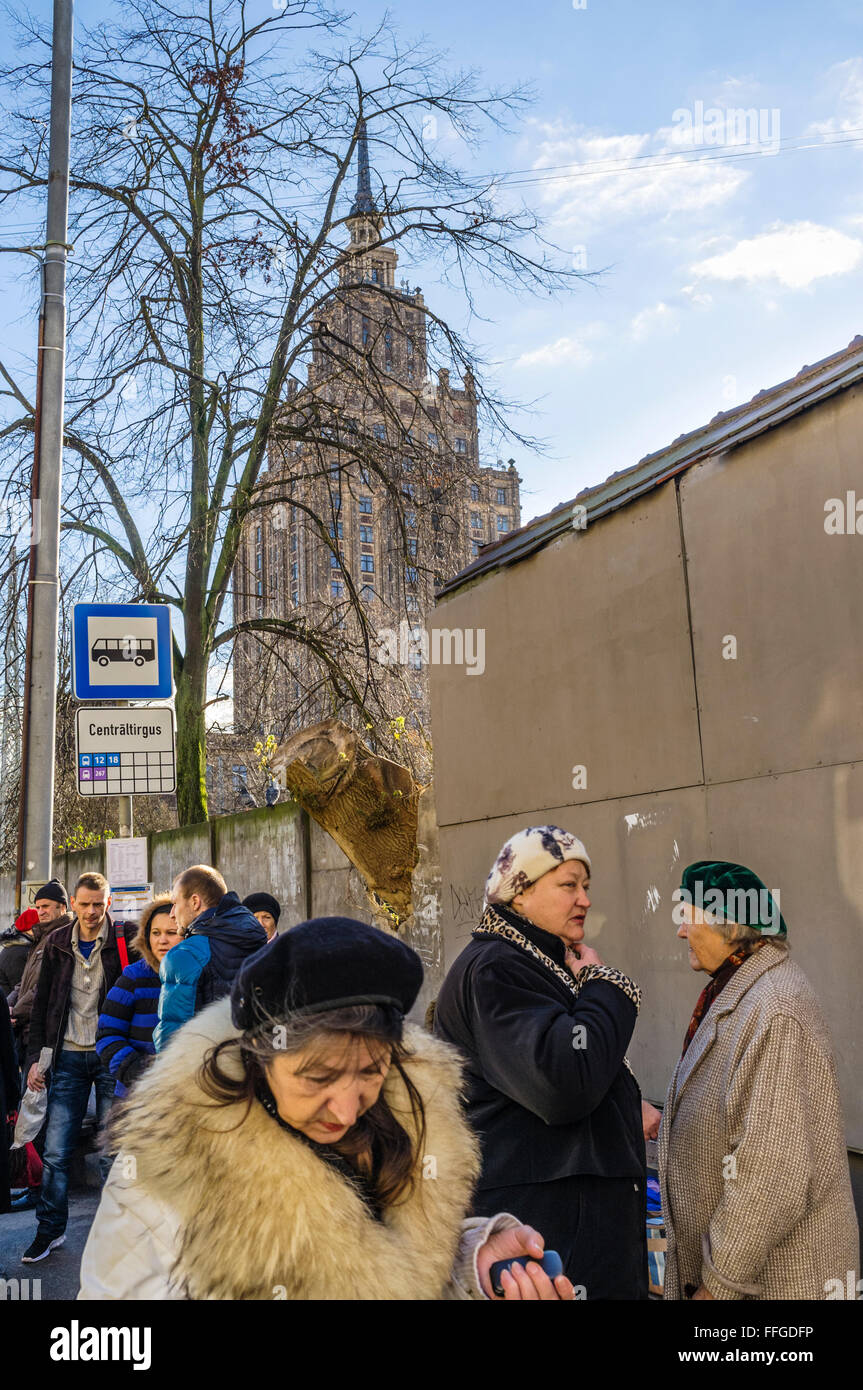 Latvian women at a bus stop with the Academy of Sciences soviet ...
