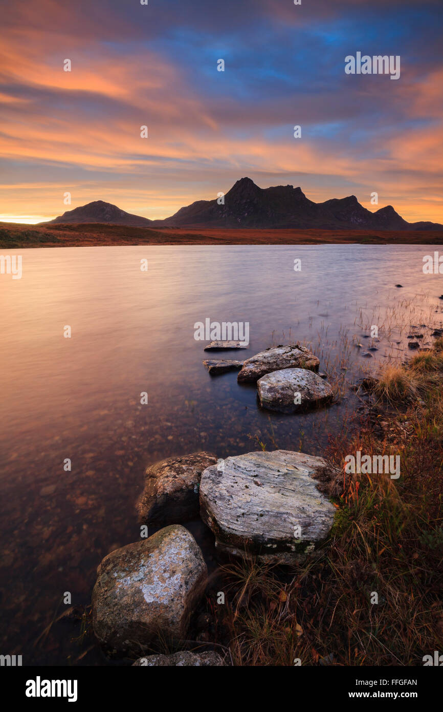 Rocks on the shore of Loch Hakel captured at sunrise in early November ...