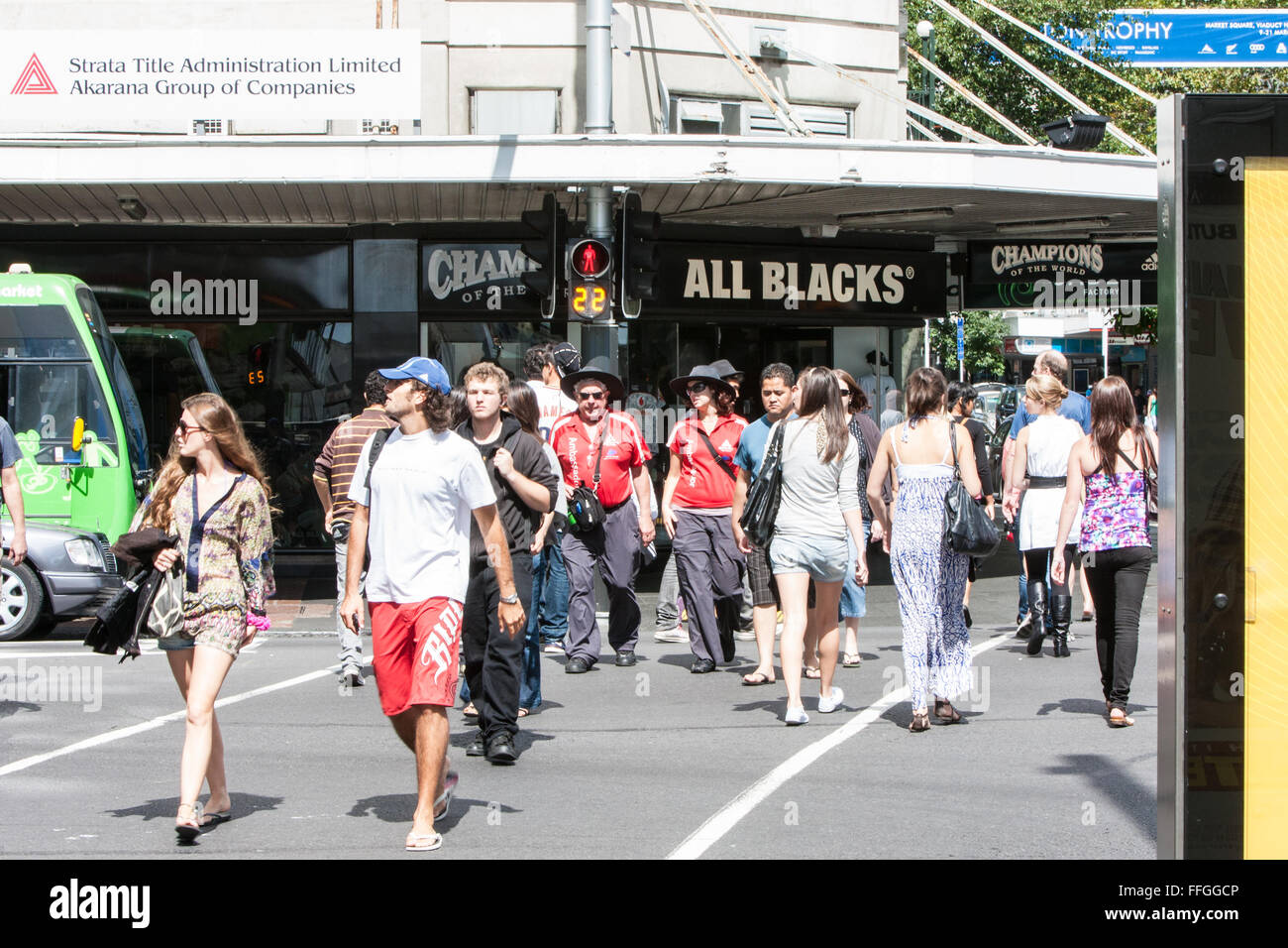 Locals and tourists crossing road,with countdown timing, at Queen ...