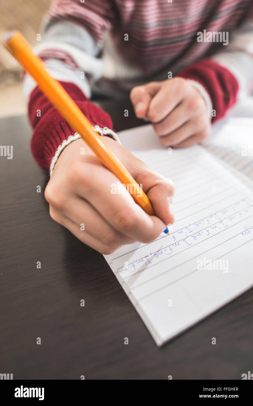 Child write in a notebook. Close up hand and pen Stock Photo - Alamy