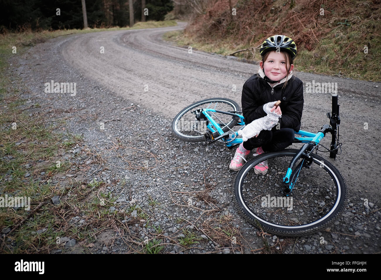 Girl cycling her bike on a trail in woodland Stock Photo - Alamy