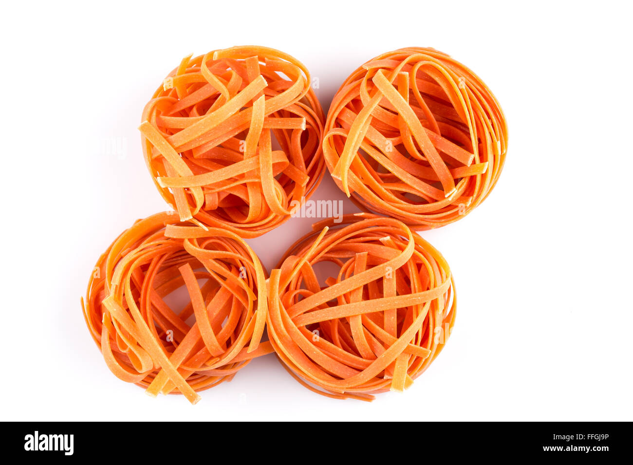 chilli orange fettuccine pasta on white background Stock Photo - Alamy
