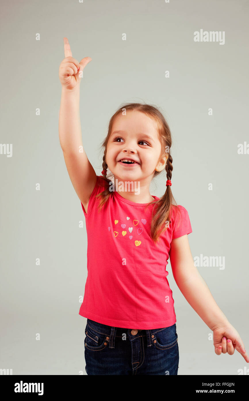 Cute child smiling and pointing up Stock Photo - Alamy