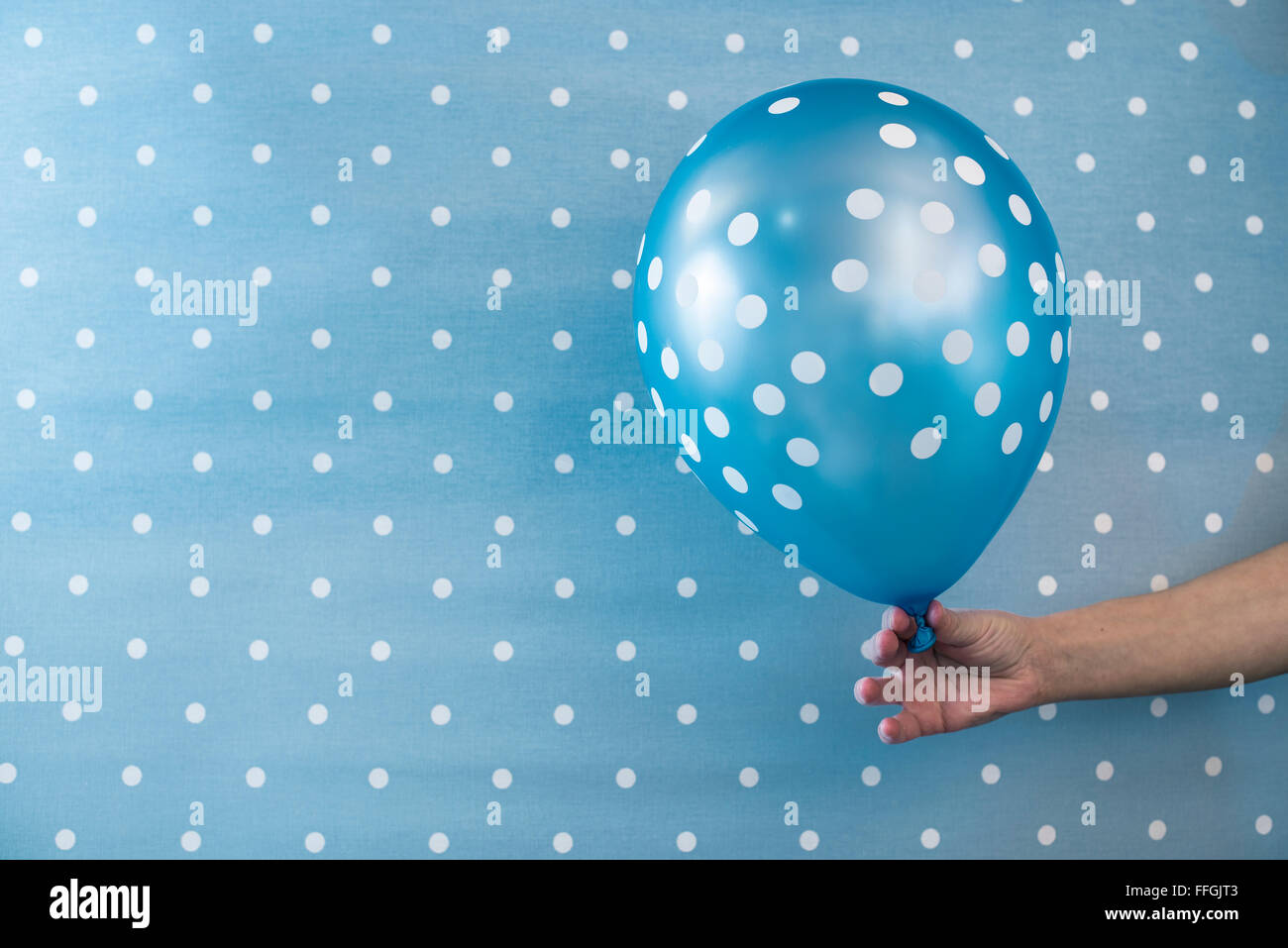 Balloon with white points on blue background Stock Photo - Alamy