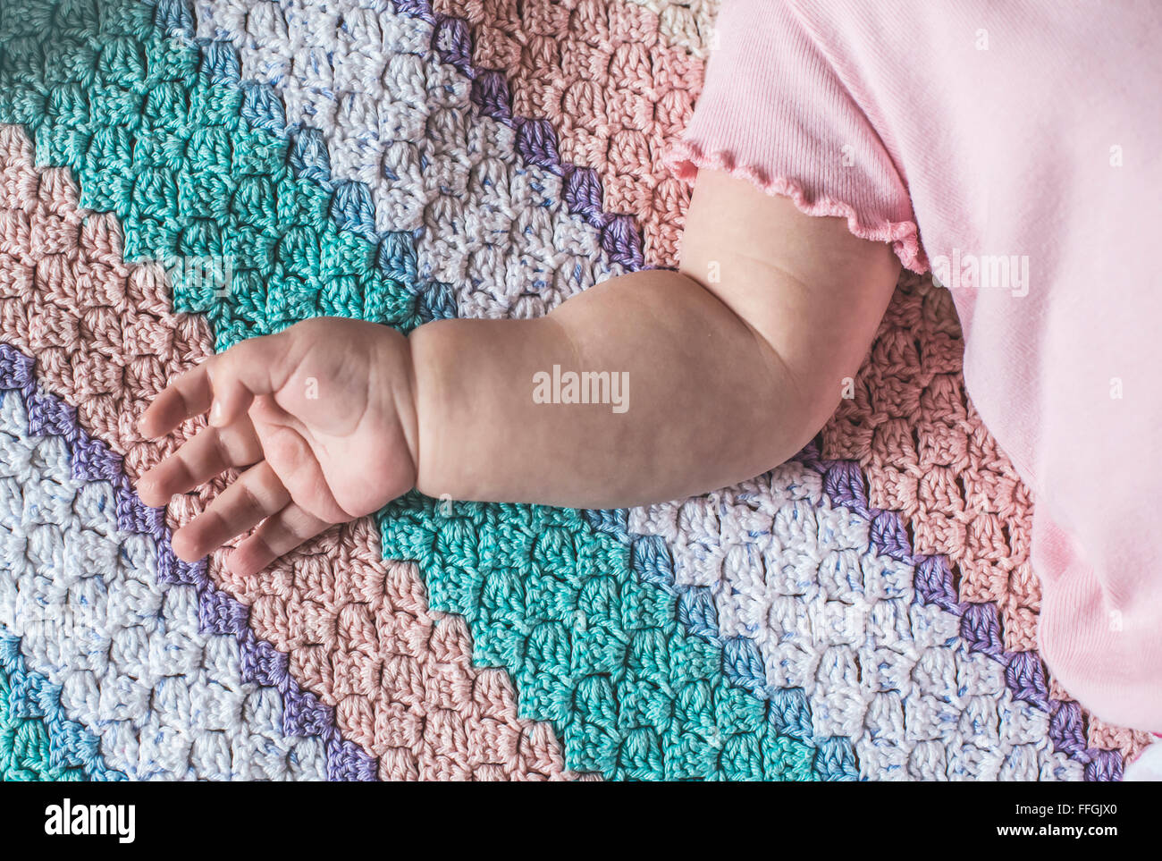 Baby hand on bed Stock Photo - Alamy