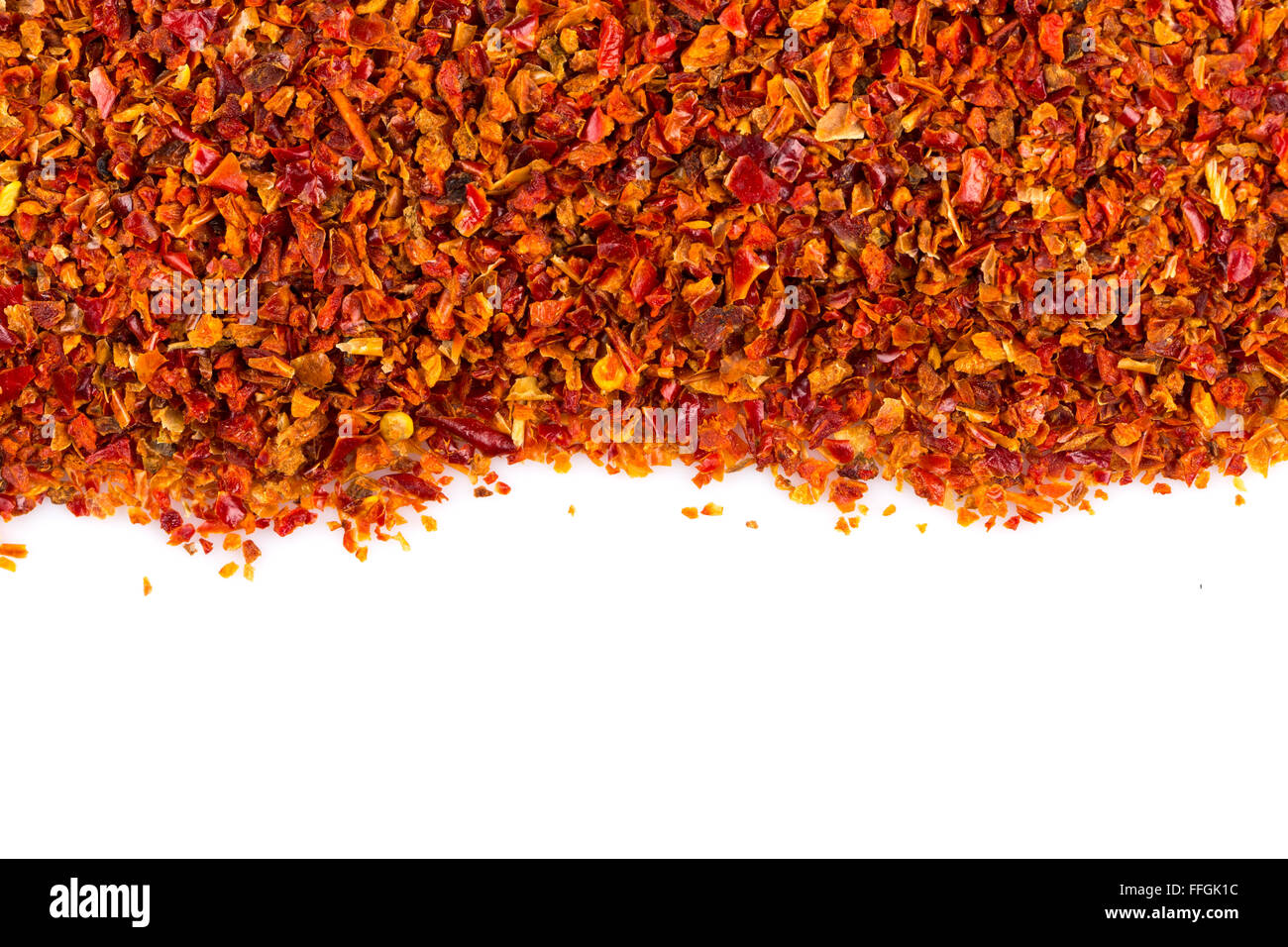 Crushed red chili pepper on white background Stock Photo - Alamy