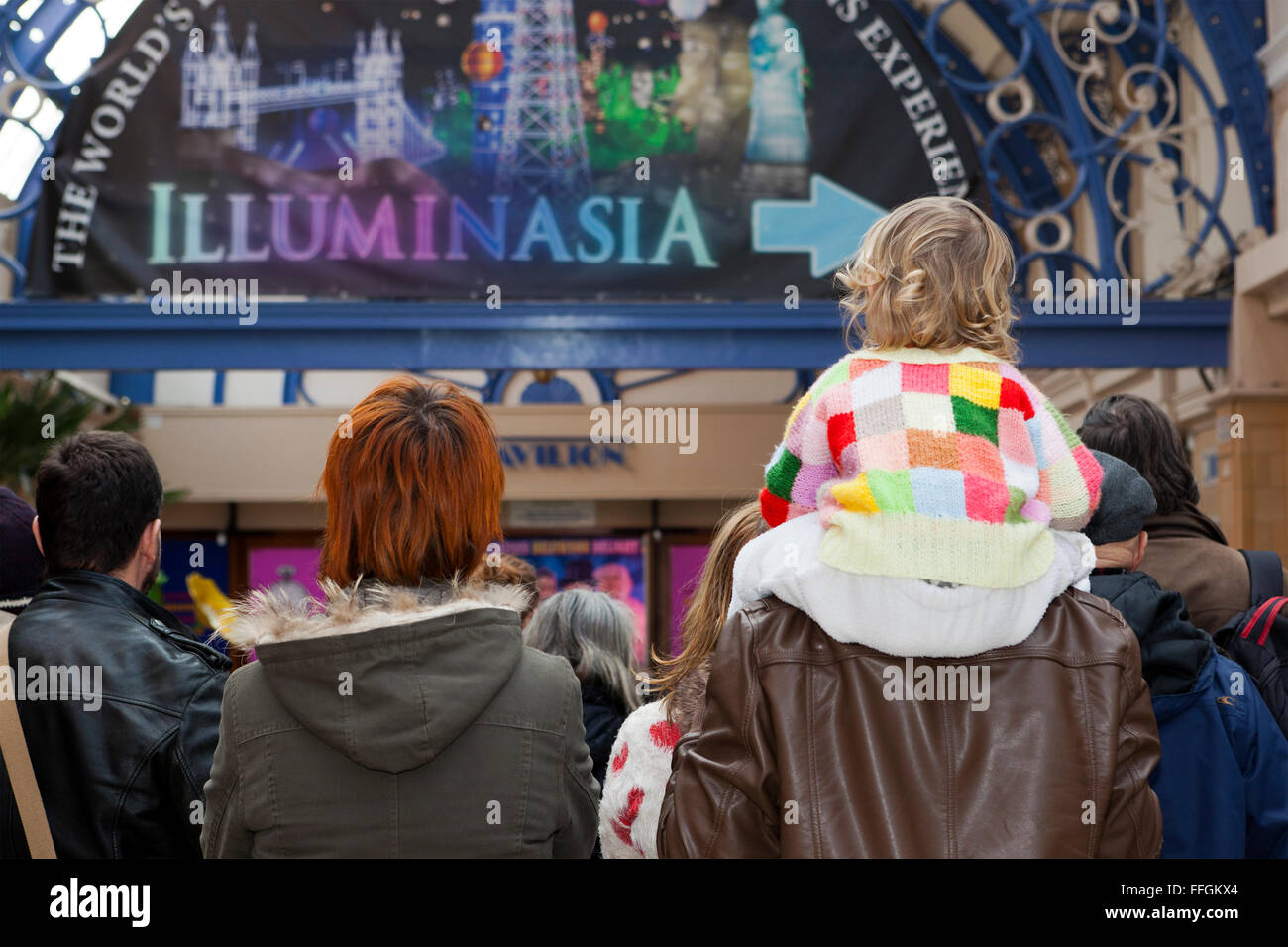 Parents queue with their children on the first day of half term for the ...