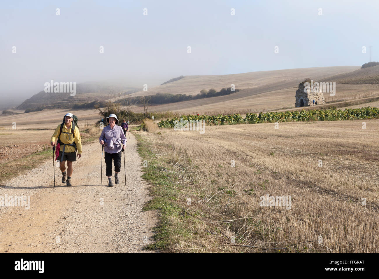 Villafranca Montes de Oca, Spain: Pilgrims walking near the ruin of the ...